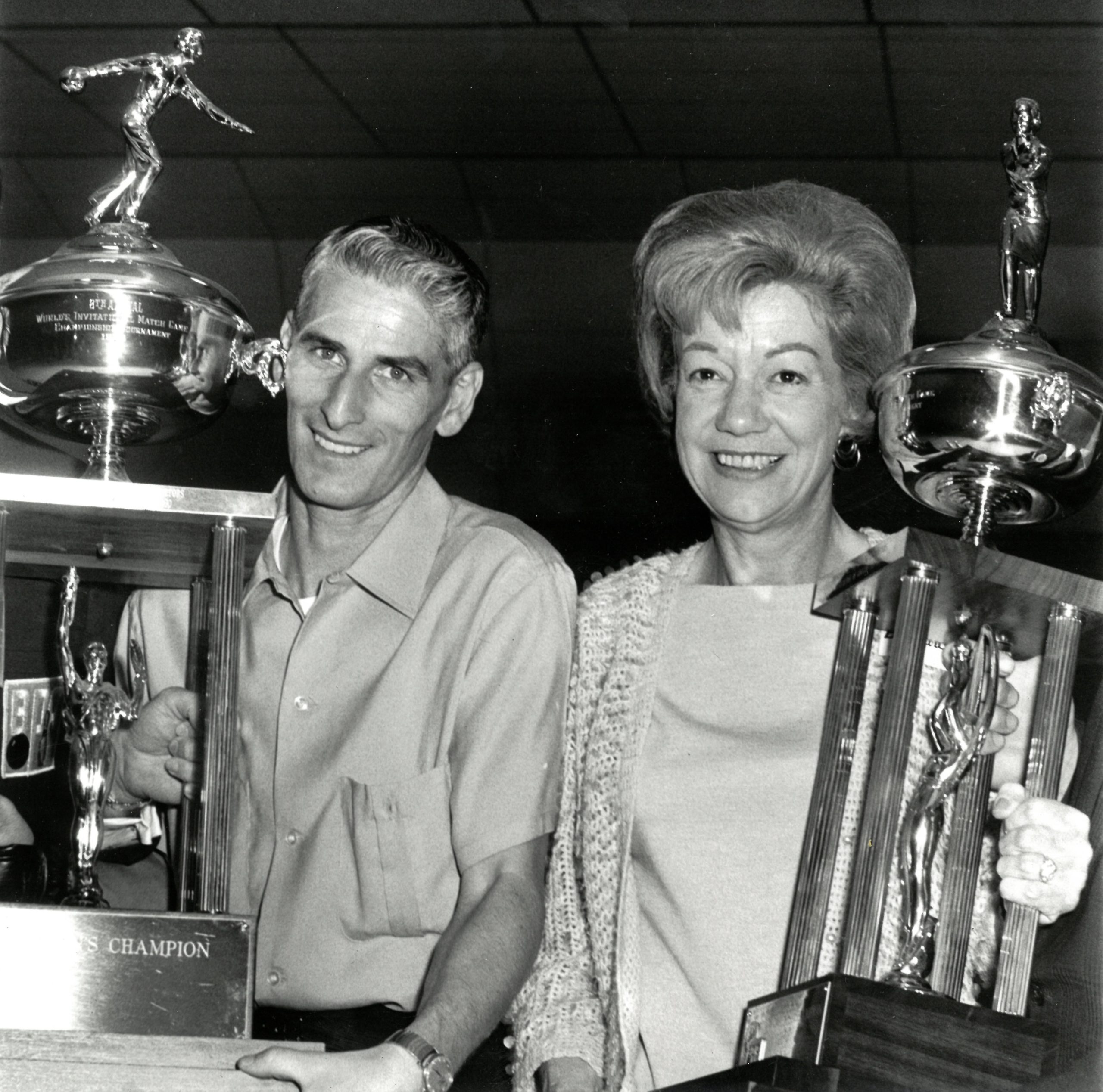 Marion Ladewig and Jim St. John Holding Trophies